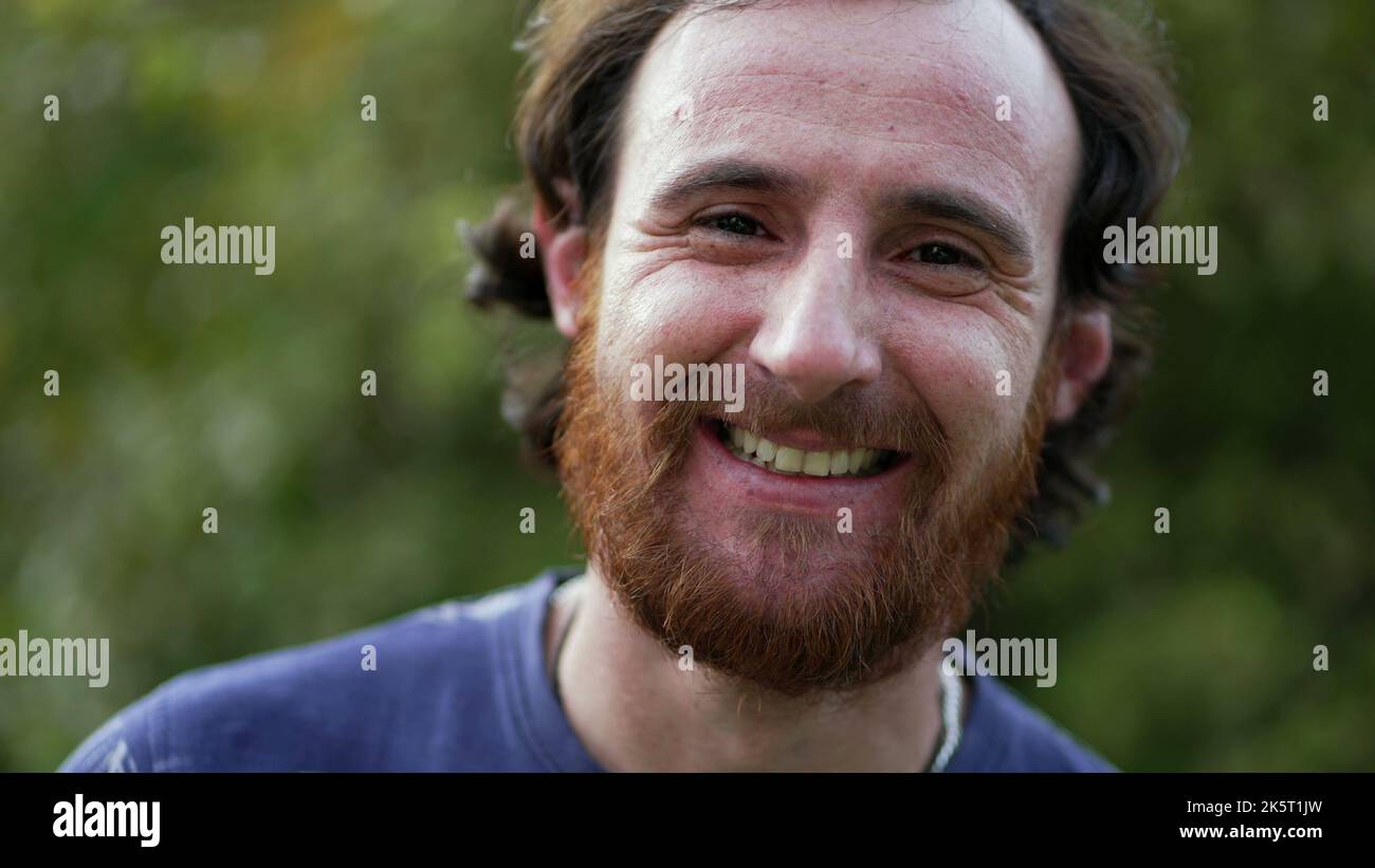Closeup face of a red hair casual man with beard smiling at camera ...