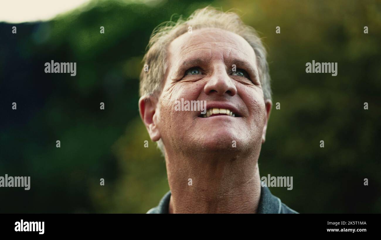 Grateful mature man smiling at sky with HOPE. One faithful senior ...