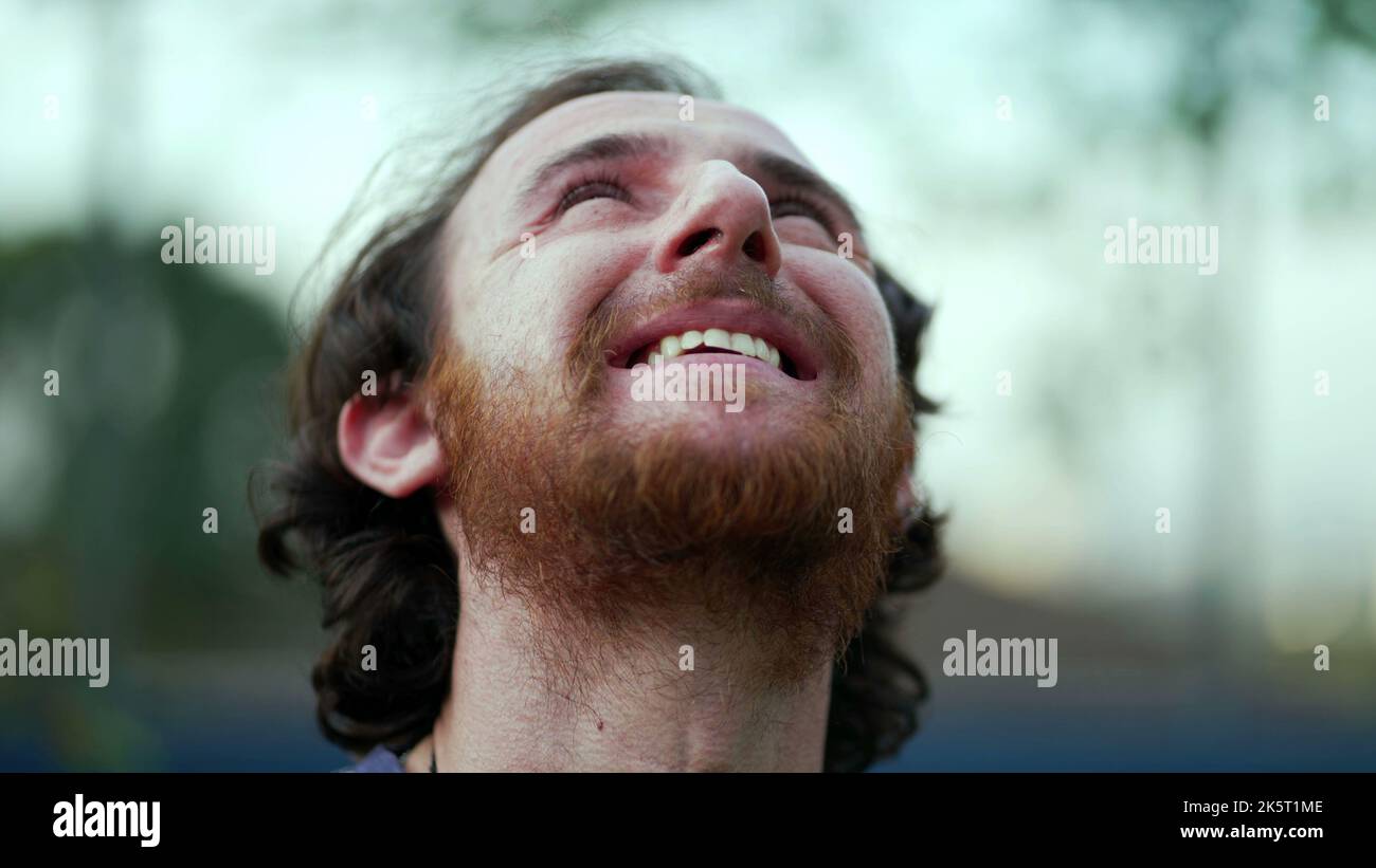 Grateful man smiling at sky with HOPE. One faithful person standing ...