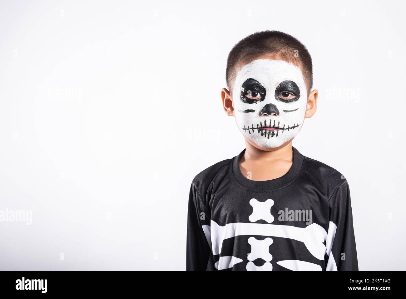 Halloween Kid. Portrait of Asian little kid boy wearing skeleton ...