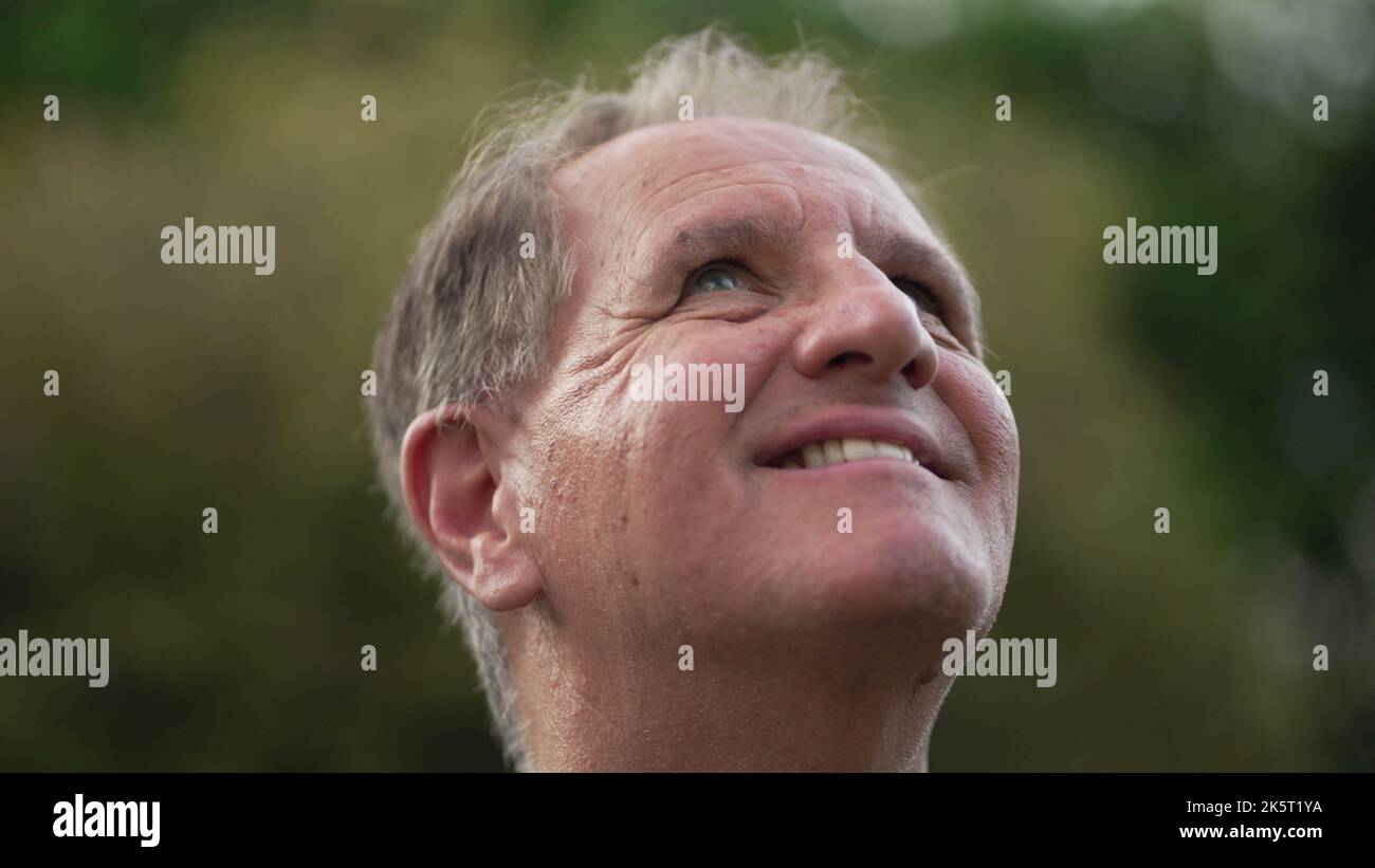 Happy Mature man closeup face looking up at sky with HOPE and FAITH ...