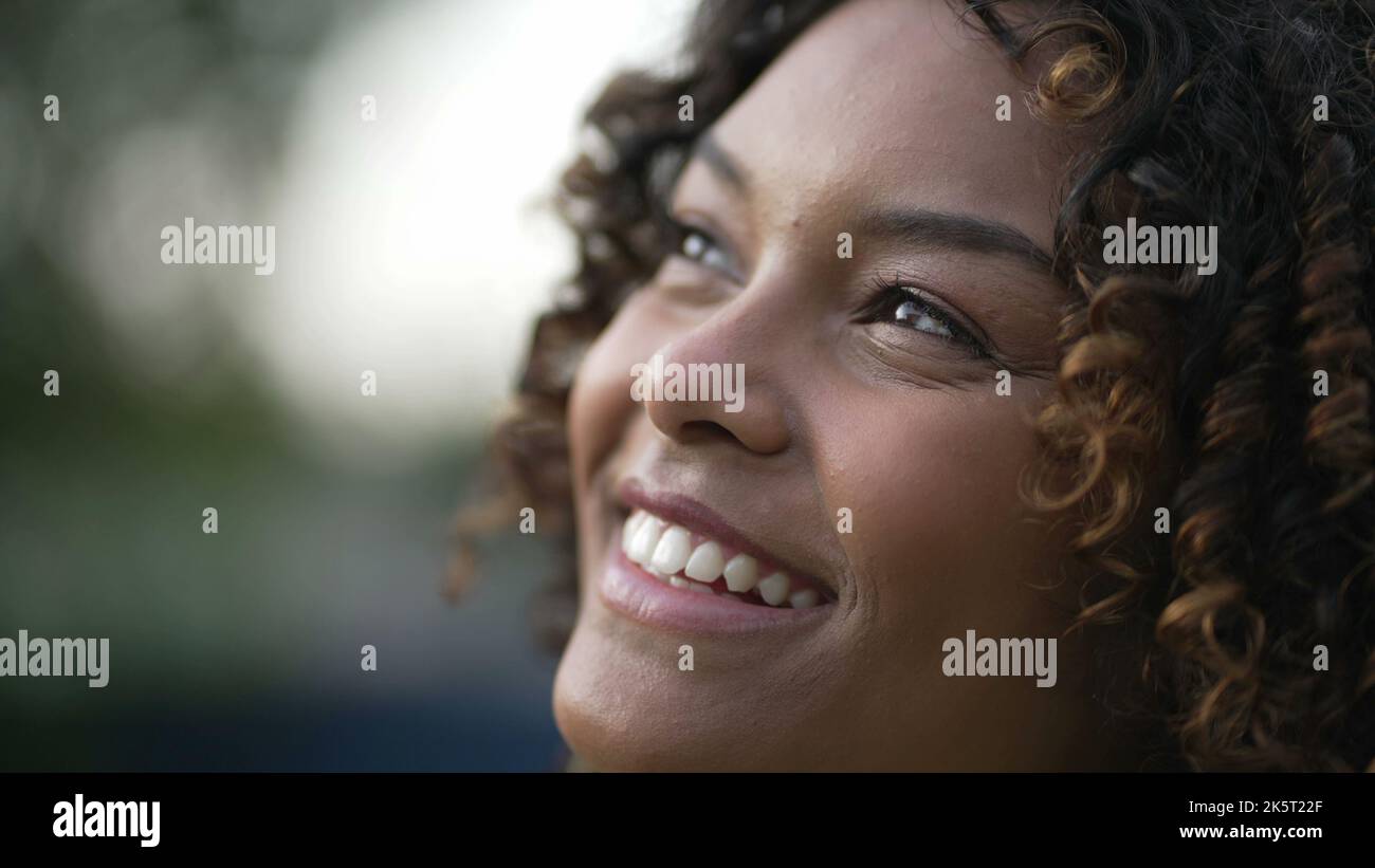 Meditative African American young woman closing eyes in contemplation ...