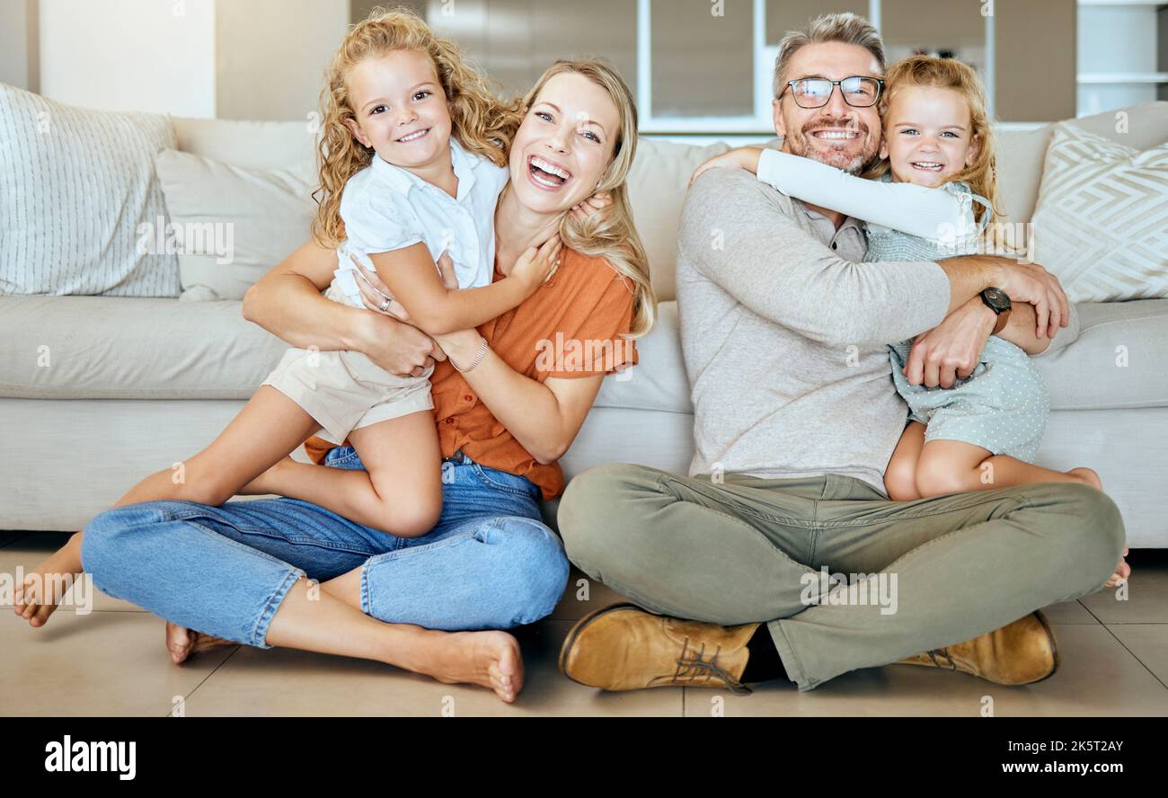 A happy Caucasian family of four relaxing in the living room at home ...