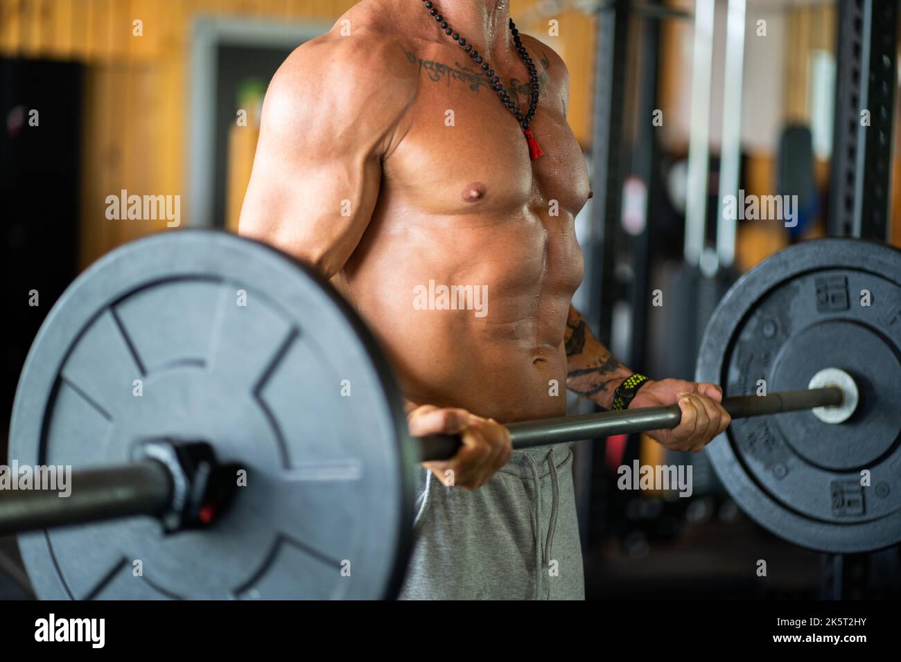 Muscular strong sportsman lifting hi-res stock photography and images ...