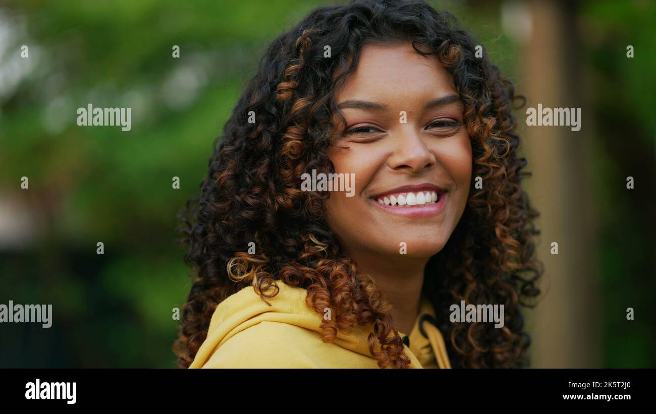 South American black girl standing outdoors looking at camera. Portrait ...