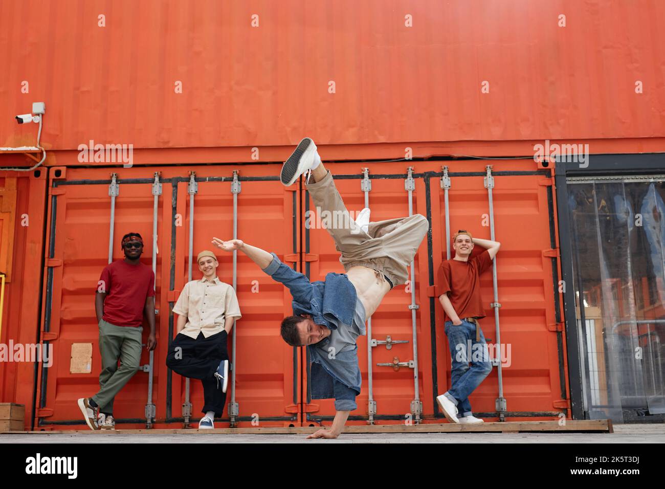 Motion shot of all male dance team performing hip-hop and breakdance in ...