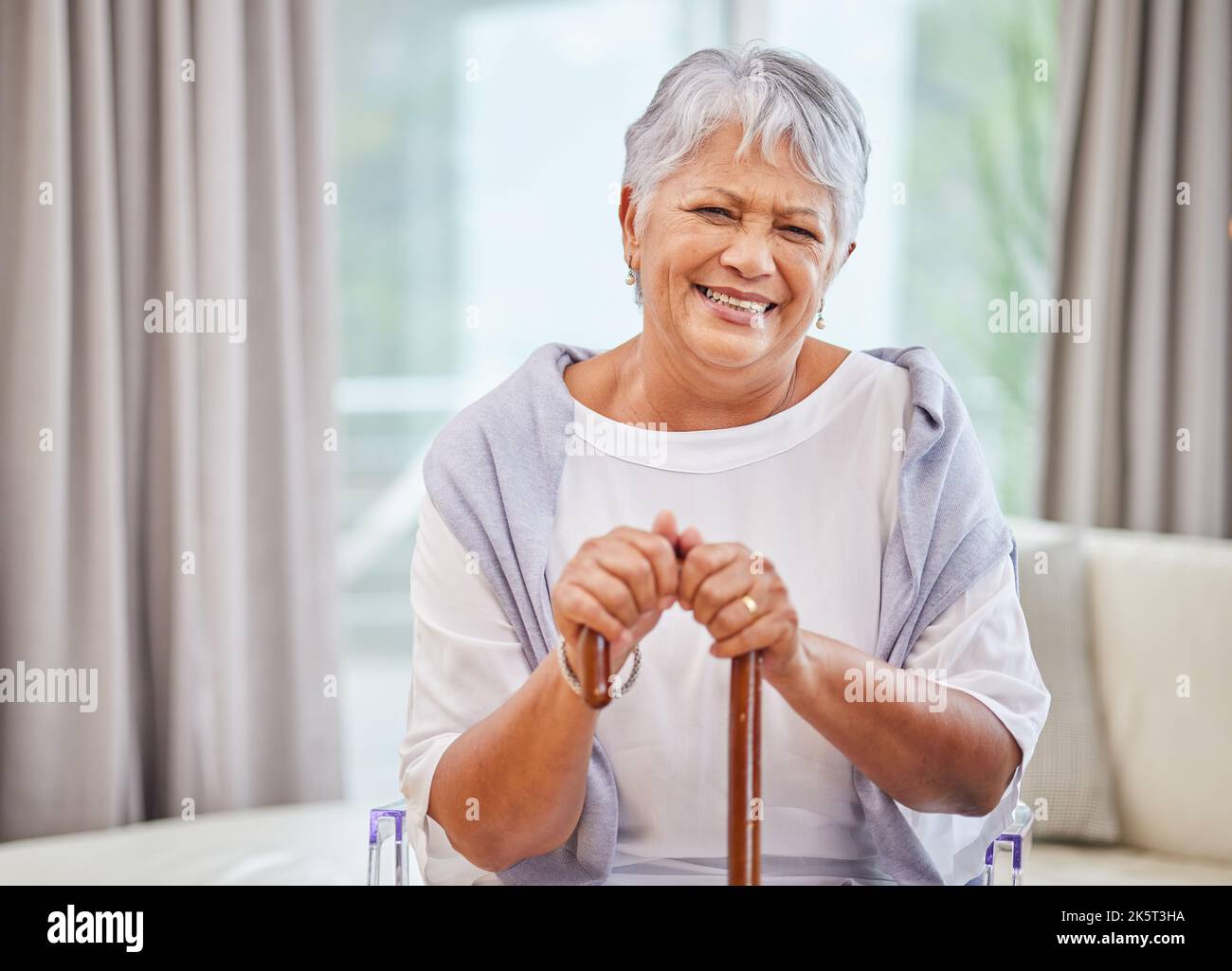 Portrait Of A Senior Hispanic Woman Leaning In Her Walking Stick At
