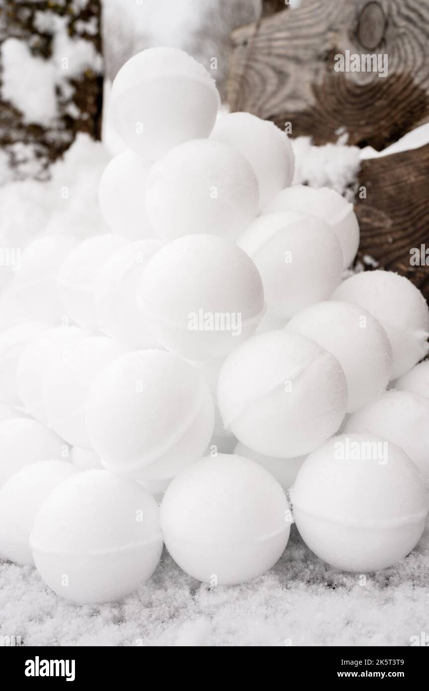 pyramid or a pile of perfect snowballs on frosty winter day in forest ...