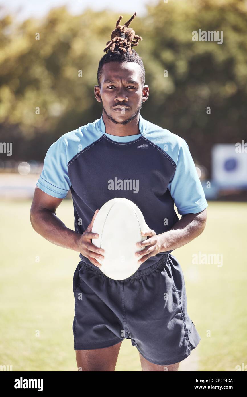 Portrait one young african american rugby player holding a rugby ball ...