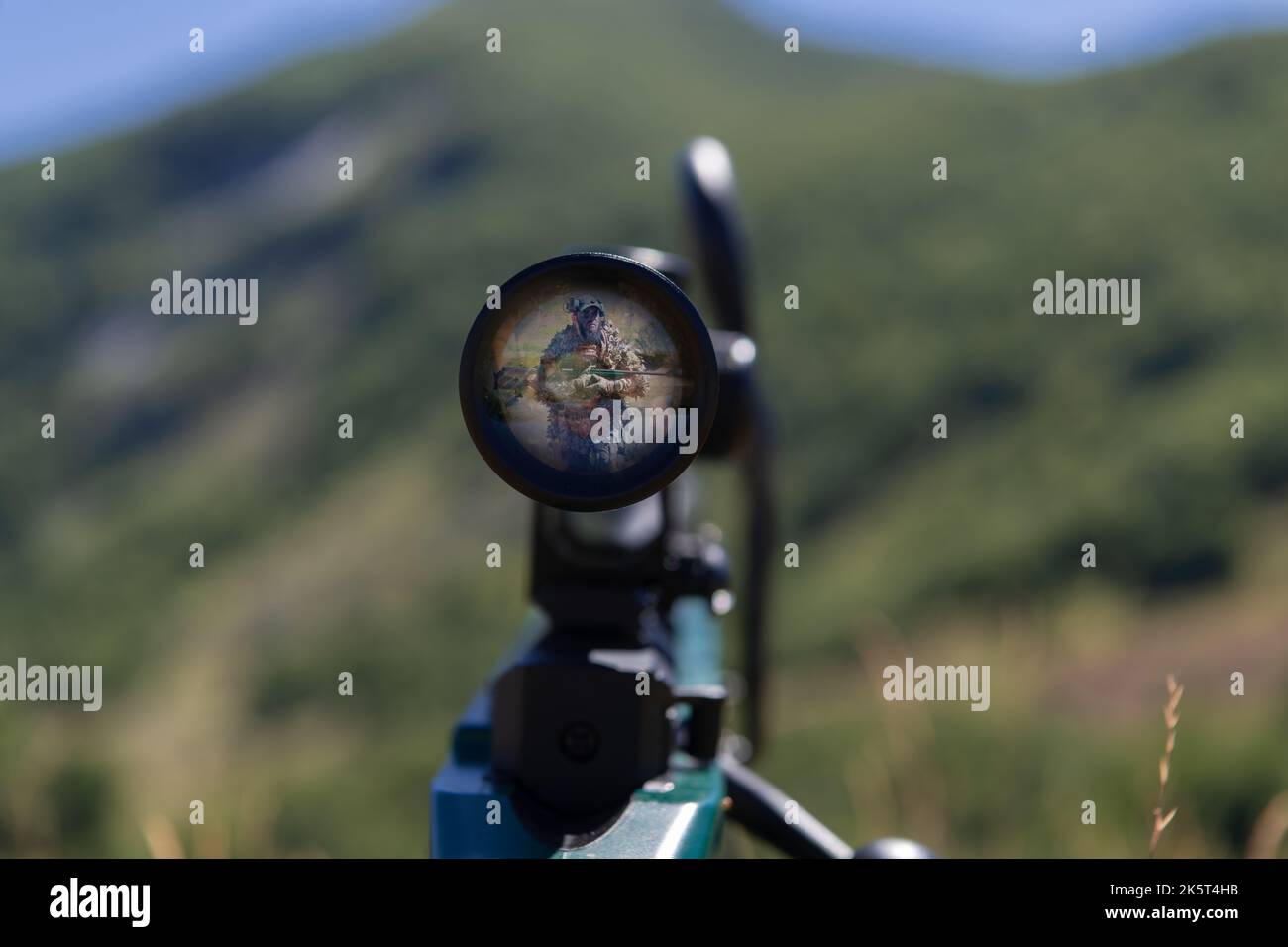 A green military sniper rifle with a scope for long distance tactical ...