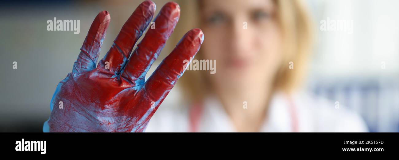 Doctor showing stop gesture with gloved hand with blood closeup Stock ...