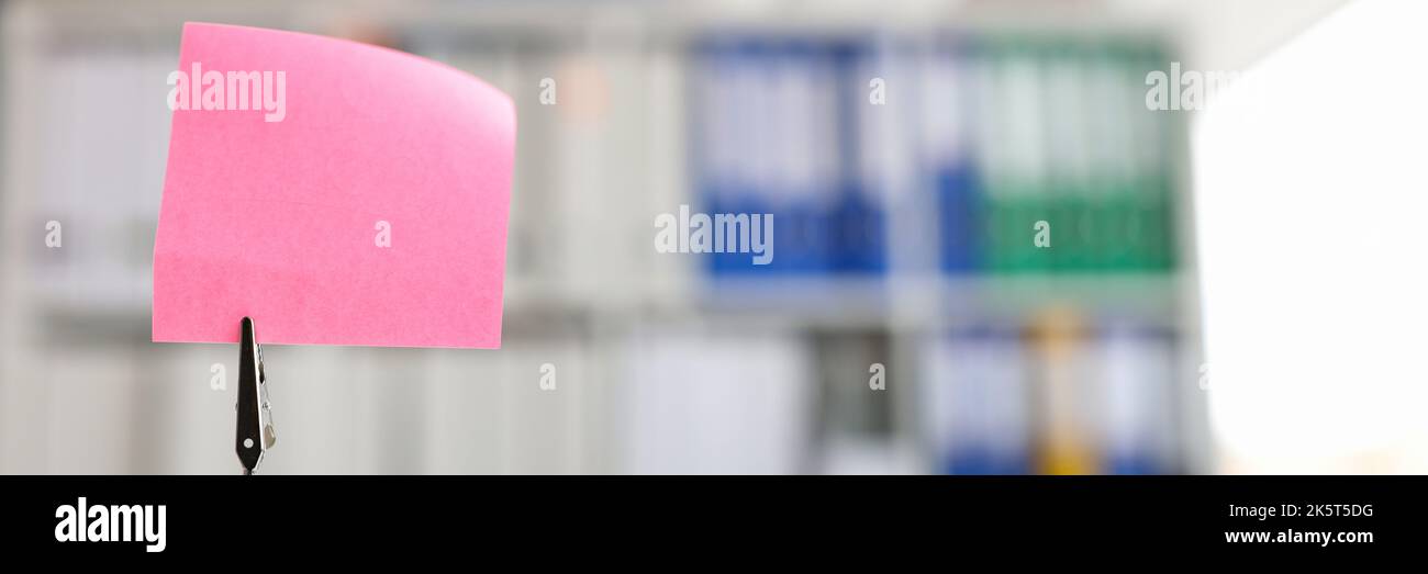 Pink reminder paper on desktop in office closeup Stock Photo - Alamy