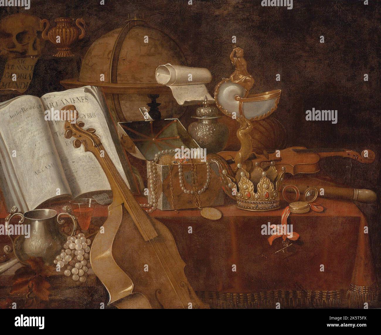 A vanitas still life with an open book, a globe, a nautilus goblet, a ...