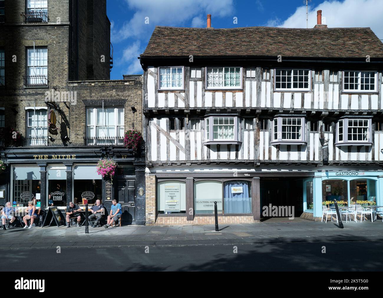Locals sit outside a pub drinking alcohol on a hot summer day, Bridge ...