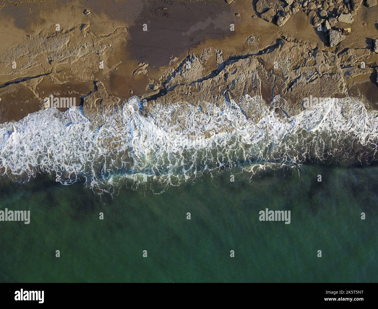 Aerial photograph of a rocky coastline with arriving and breaking ocean ...