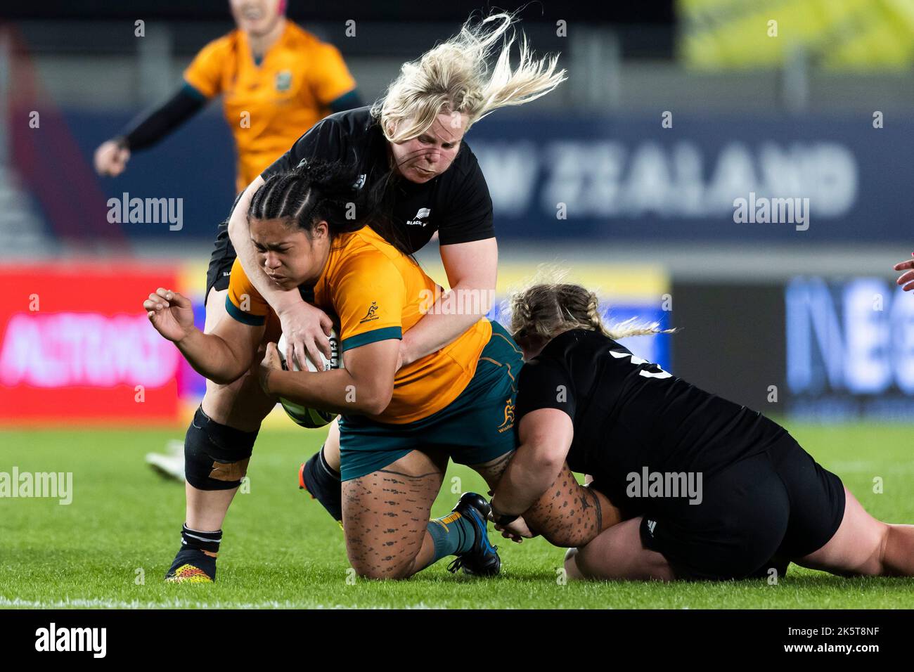 Australia's Liz Patu is tackled by New Zealand's Phillipa Love and Amy ...