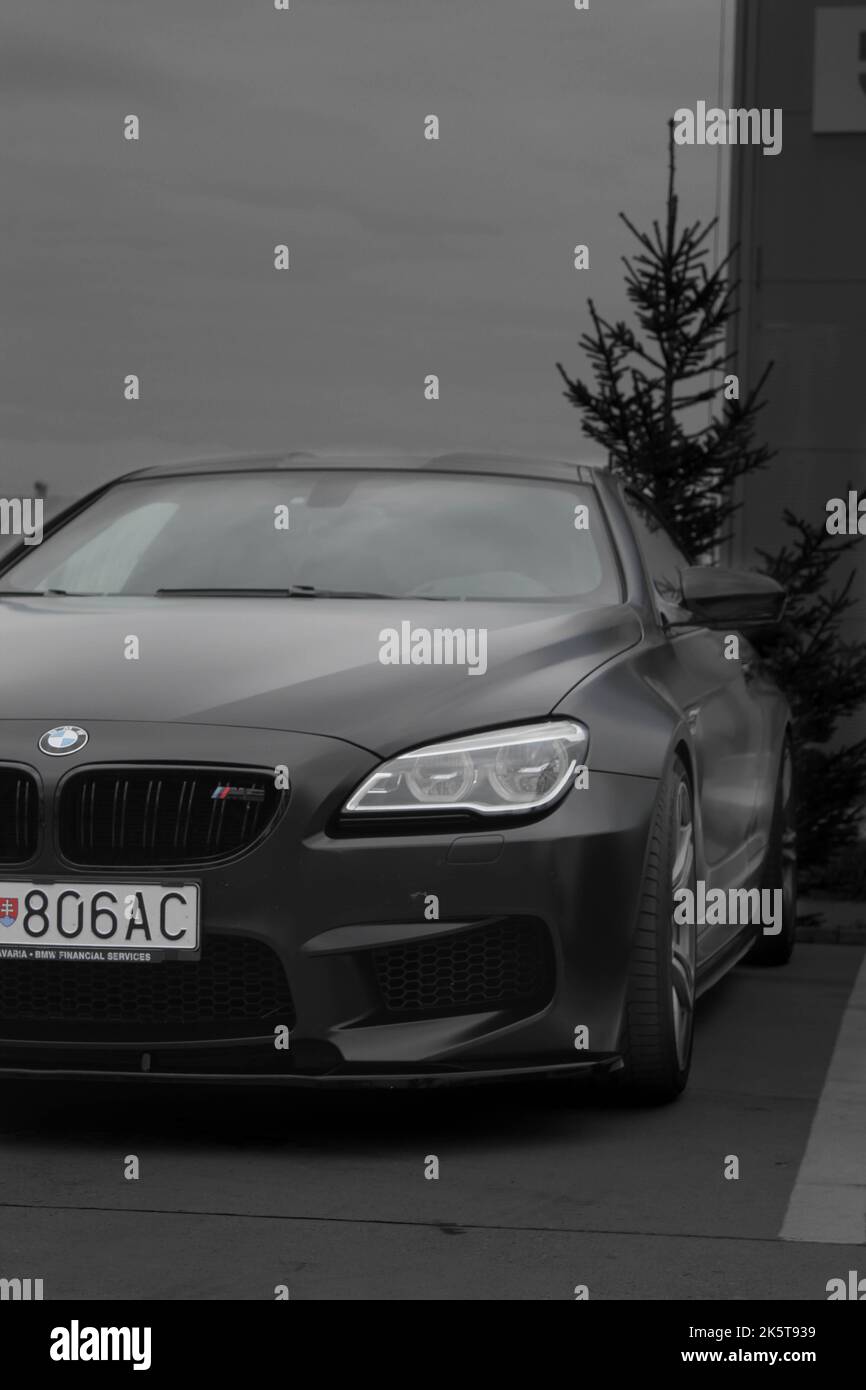 A vertical grayscale of a BMW parked outdoors Stock Photo - Alamy