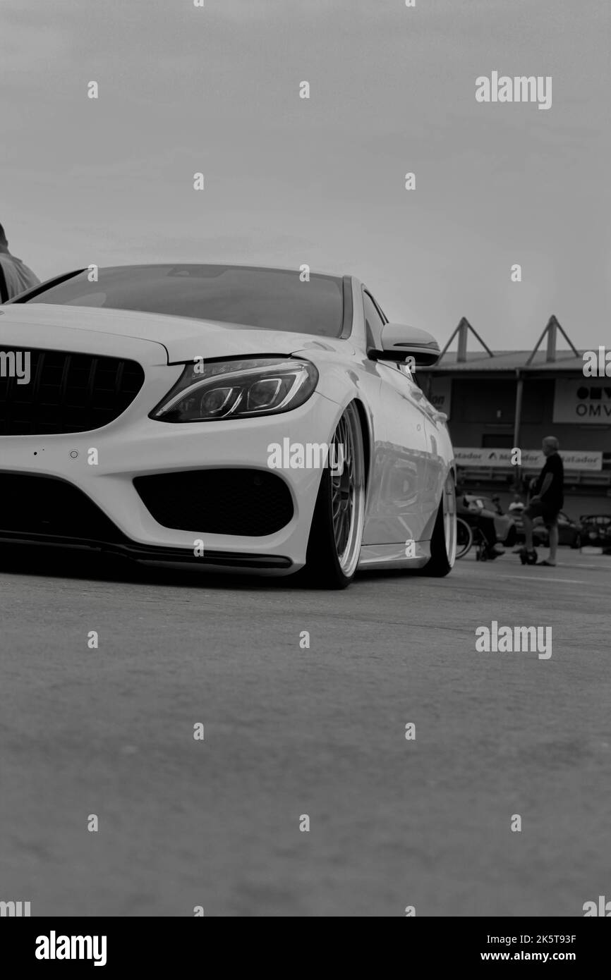A vertical grayscale of a BMW parked outdoors Stock Photo - Alamy
