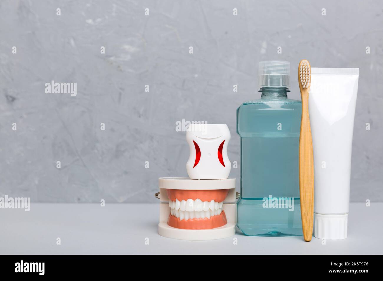 Mouthwash and other oral hygiene products on colored table top view ...