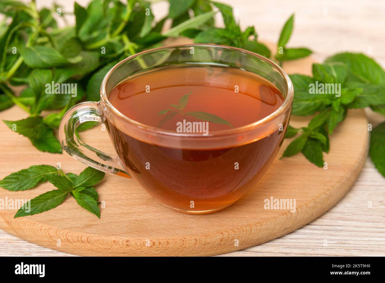 Cup of mint tea on table background. Green tea with fresh mint top view ...