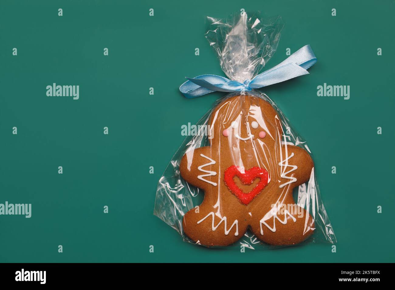 Iced Christmas Gingerbread man sugar cookie with red heart wrapped in ...