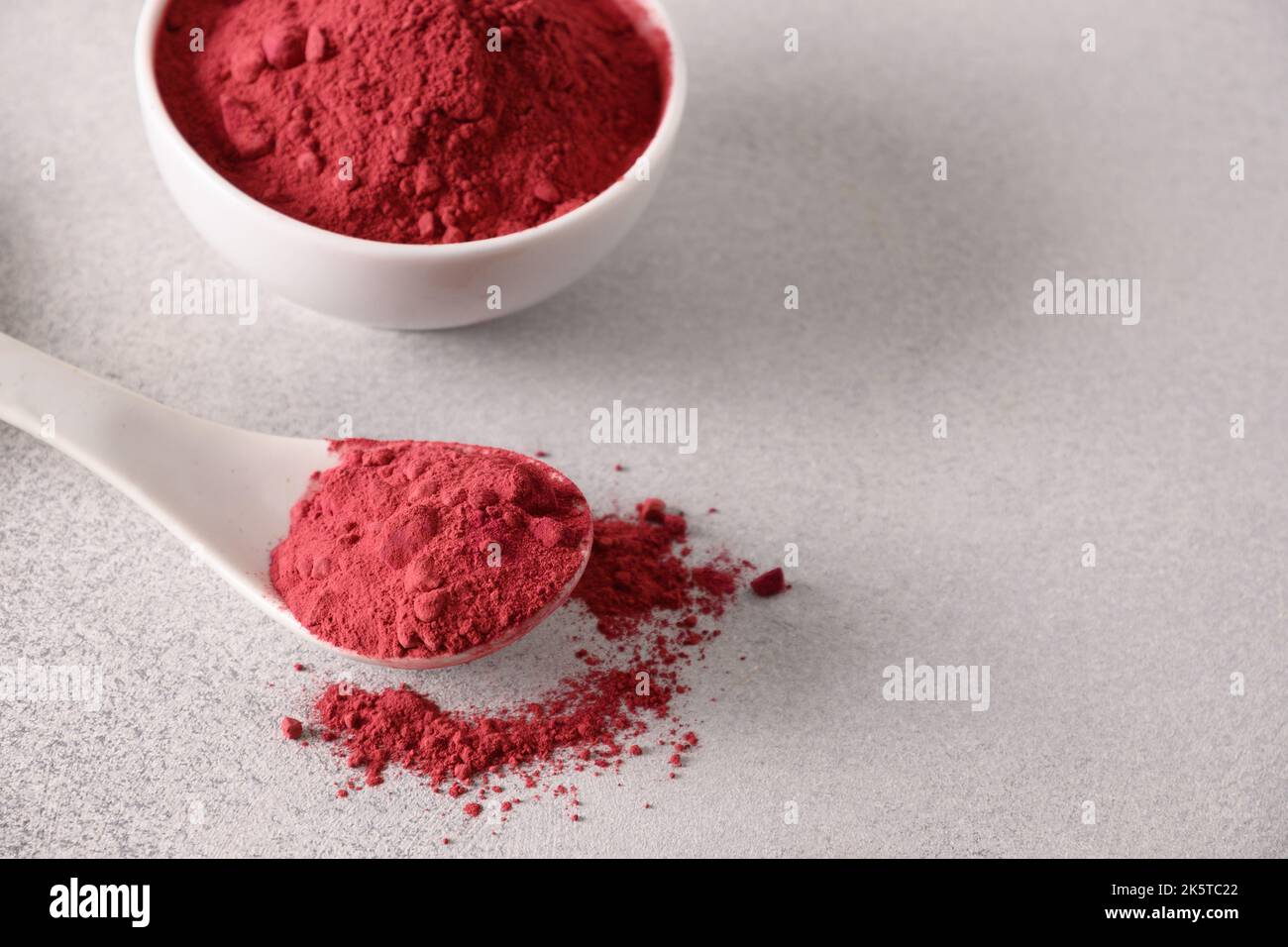 Beetroot powder for cooking healthy beverage in spoon on gray ...