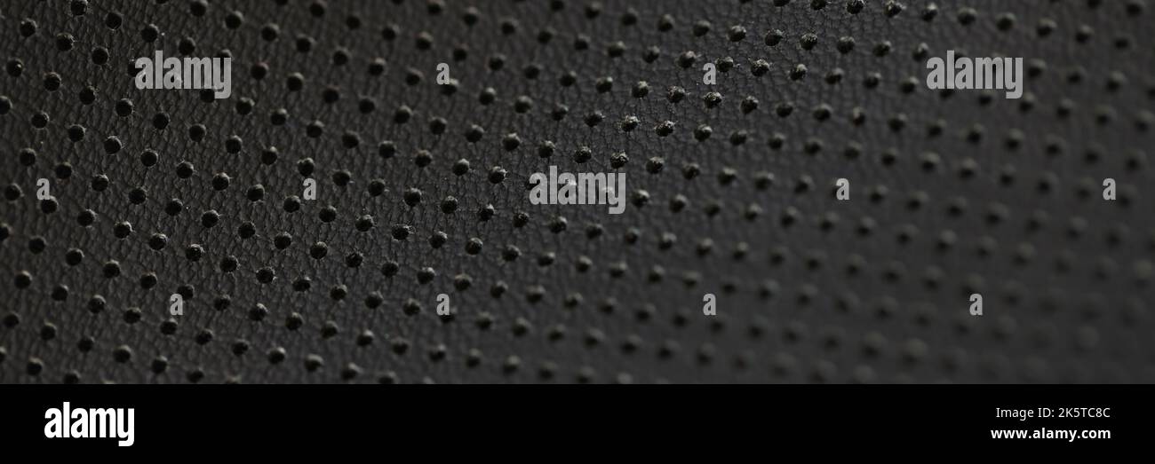 Black leather fabric pattern of small holes, wallpaper Stock Photo - Alamy