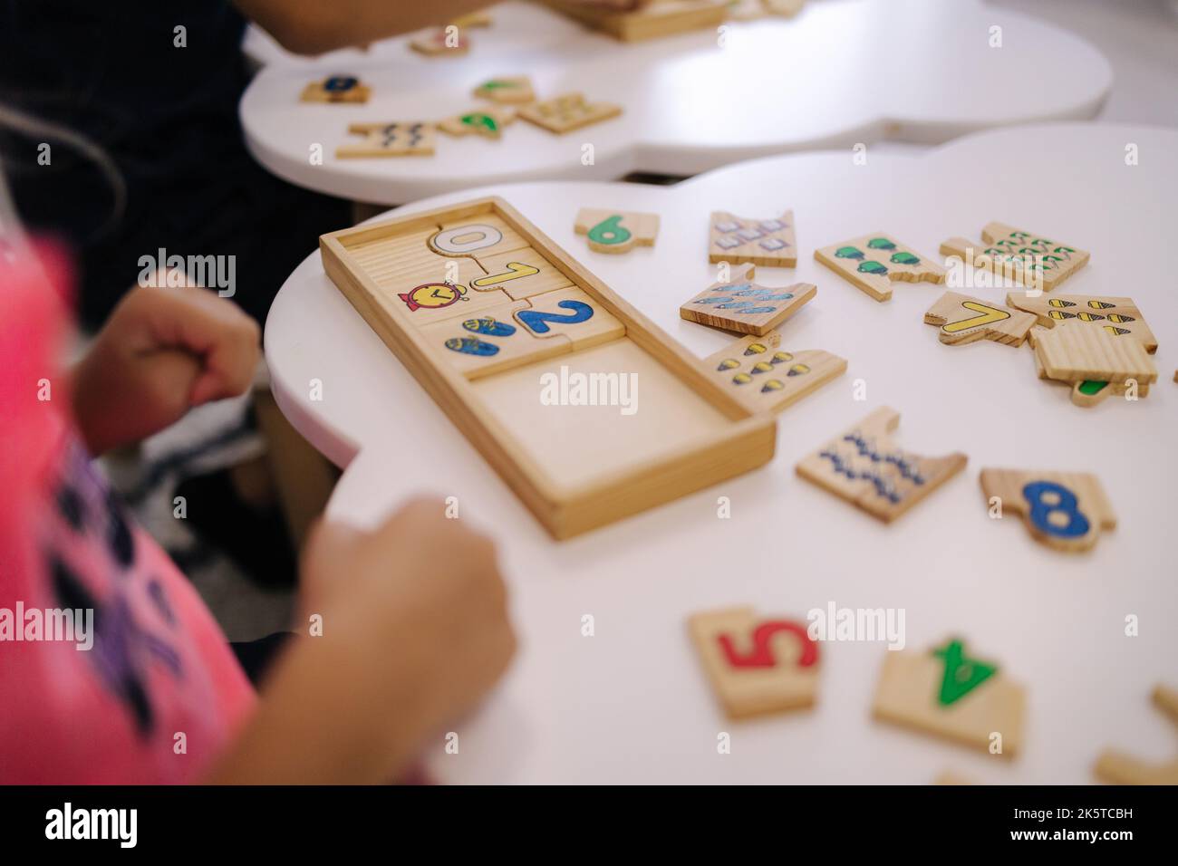 Children in kindergarten put together educational puzzles Stock Photo ...