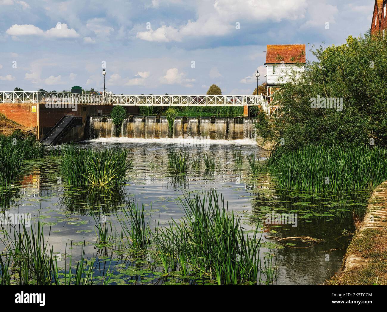 The Weir At Abbey Mill On The River Avon In The Lovely Cotswold Town Of