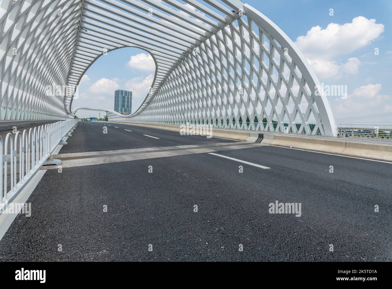 An Empty asphalt road on a bridge in downtown with cloudy sky Stock ...