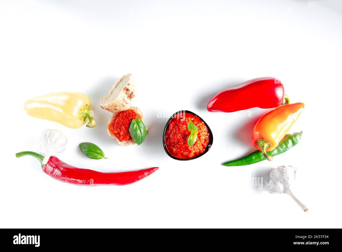 Turkish-style biber salcasi pepper paste. Black bowl with red sauce and ...