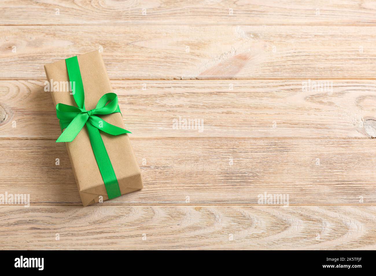 Wrapped christmas or other holiday handmade present in craft paper with ...