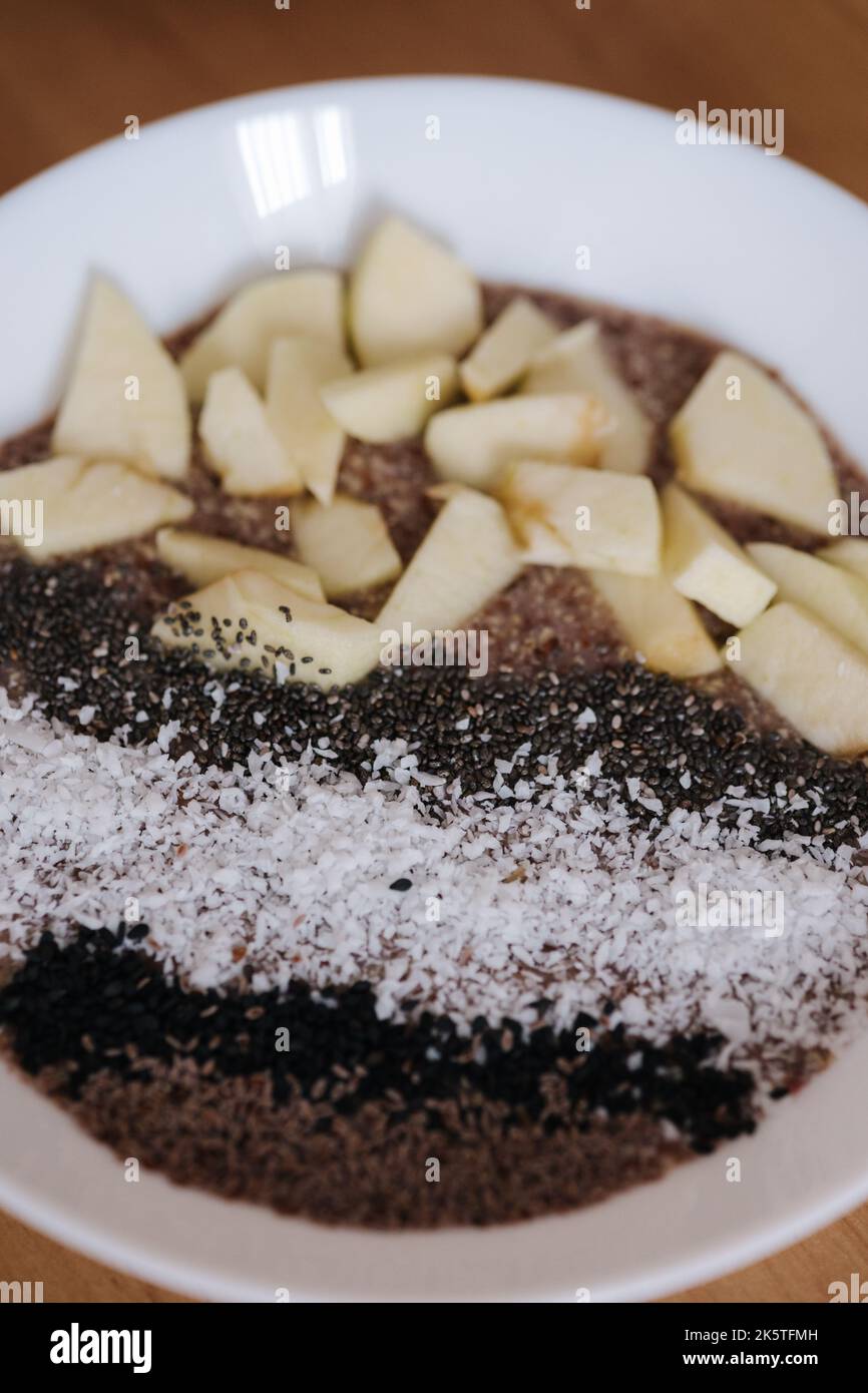 Vegan raw flaxeed porridge with fruits and chia, black sesame and ...