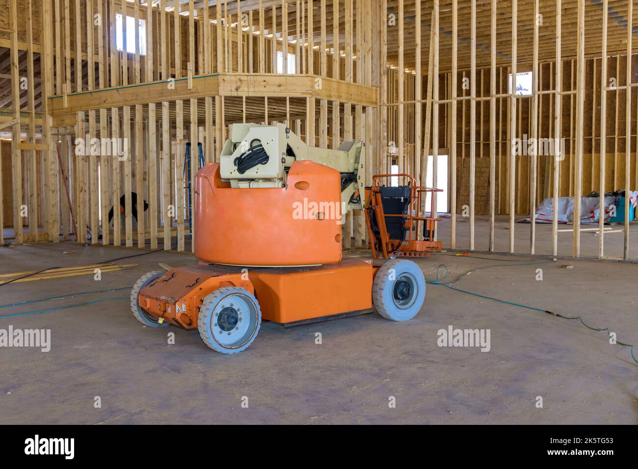 Using boom truck forklift at construction site framing beams under ...