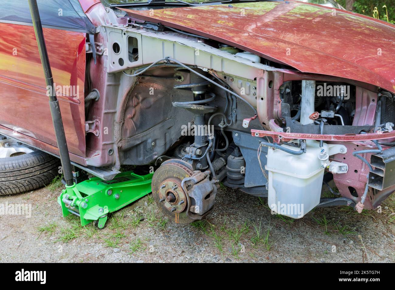 Replacing front fender on vehicle with car jack lifting vehicle after ...