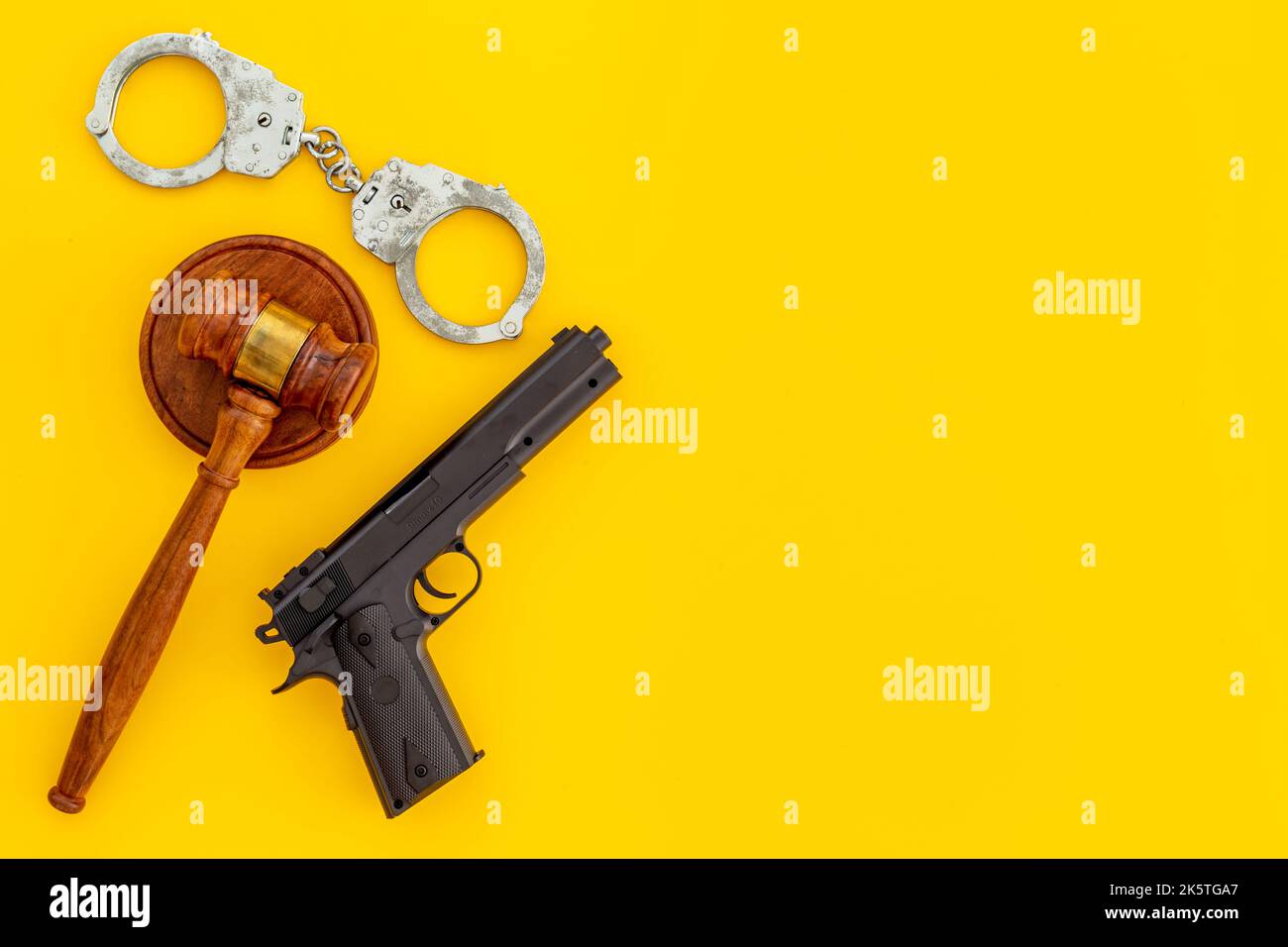 Hand gun weapon with handcuffs - illegal use of weapons concept Stock ...