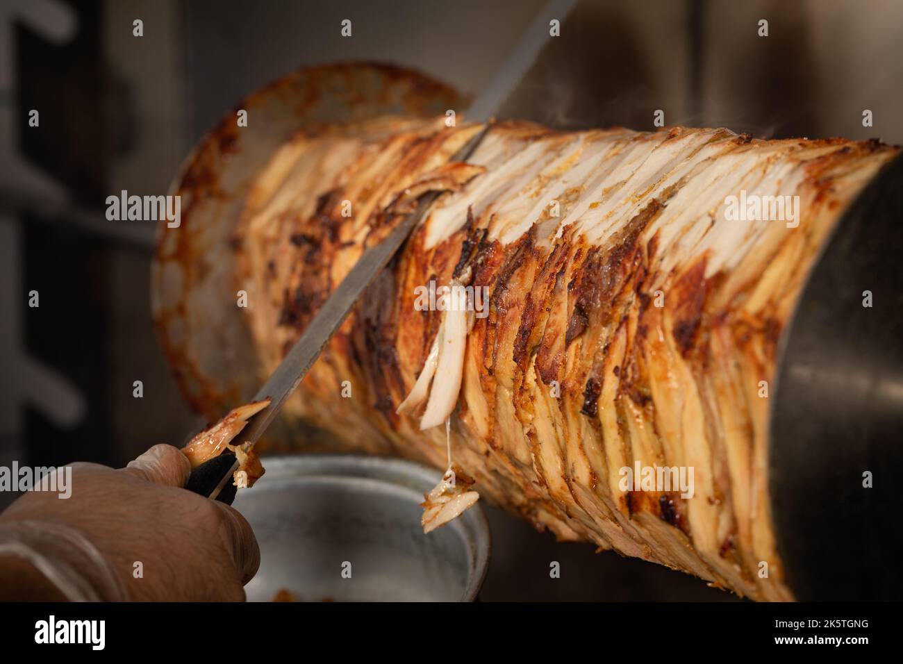 A human hand cutting with knife meat for Shawarma Stock Photo - Alamy