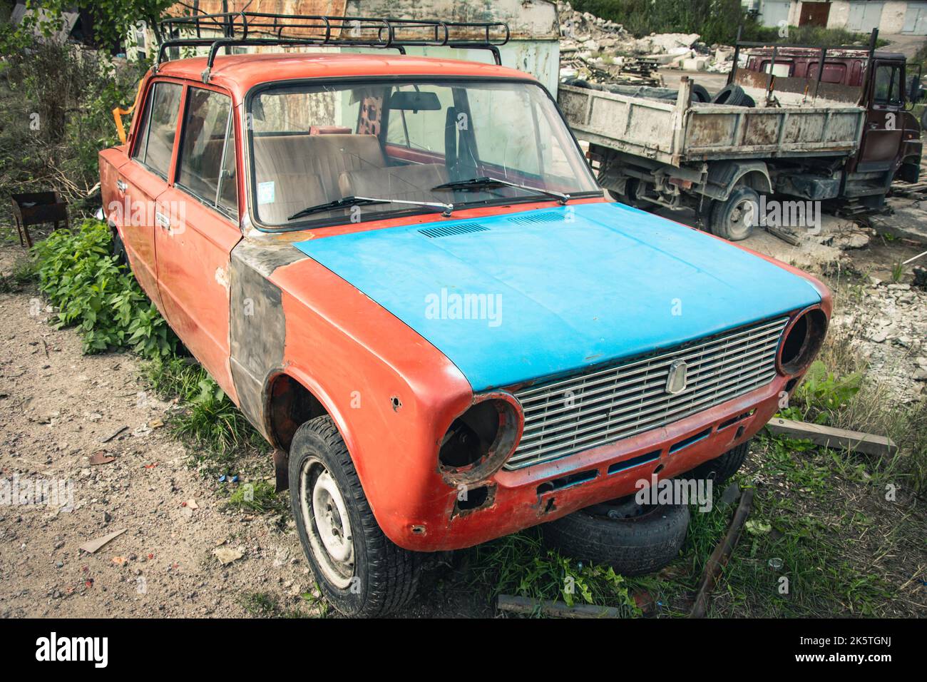 an old broken classic car abandoned on the street. stainless old ...