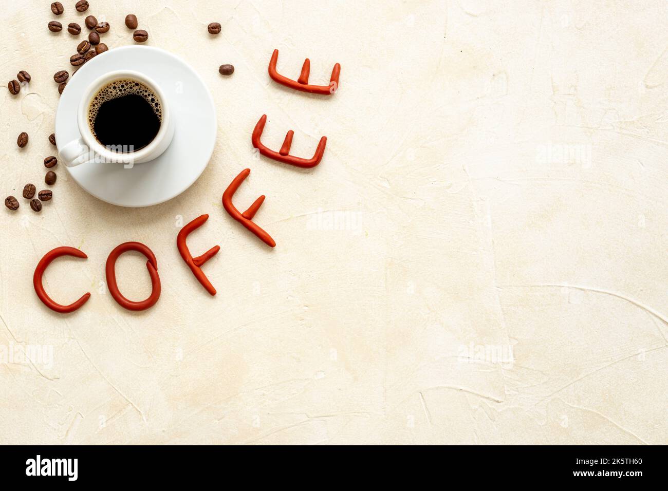 White cup of hot black coffee with rubber letters. Coffee break concept ...