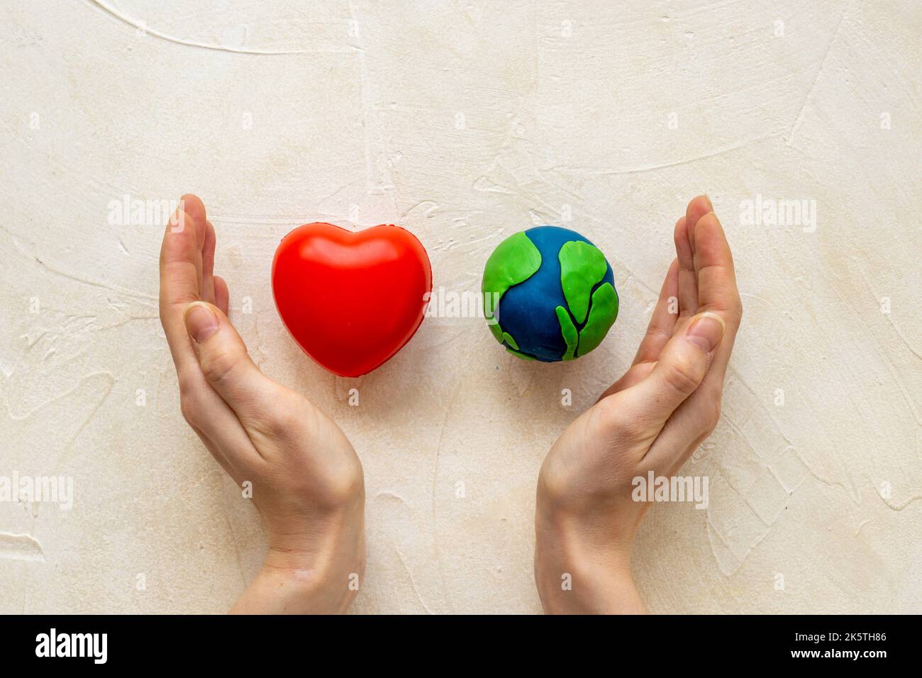 Plasticine world - planet Earth in hands. Eco care concept Stock Photo ...