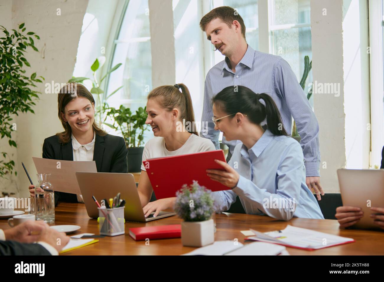 Group of mixed ages people talking, working with colleagues, co-workers ...