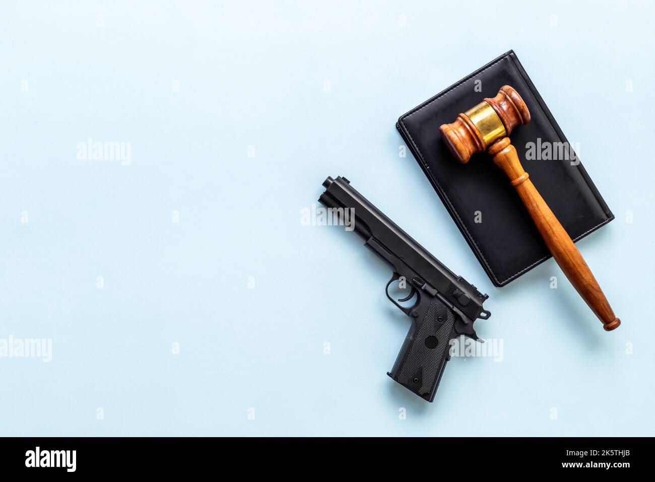 Hand gun weapon and judges gavel - gun law. Illegal use of weapons ...
