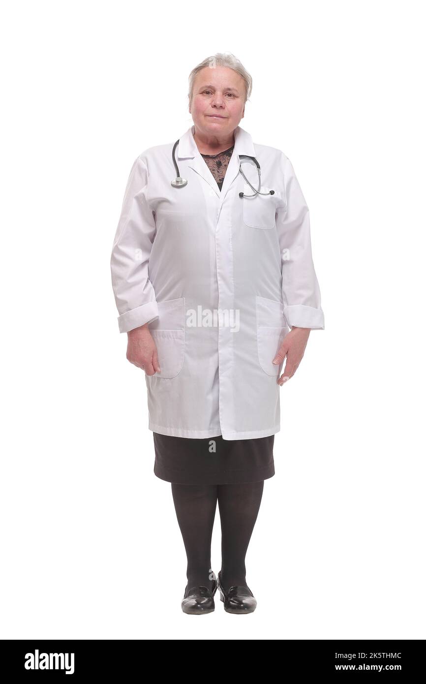 Portrait of kindly smiling senior doctor standing at white background ...