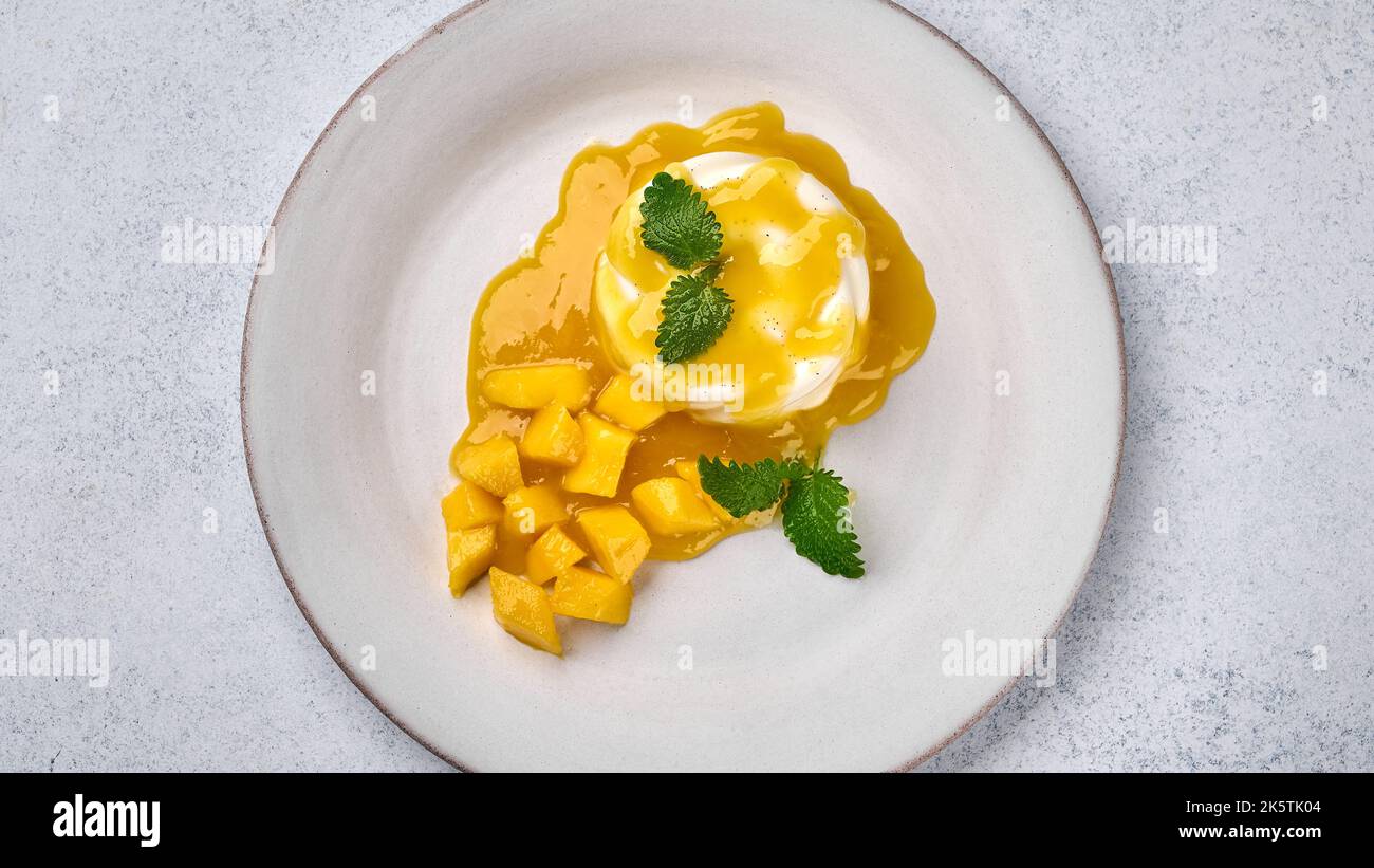 Panoramic top view panna cotta with natural vanilla pod, mango syrup ...