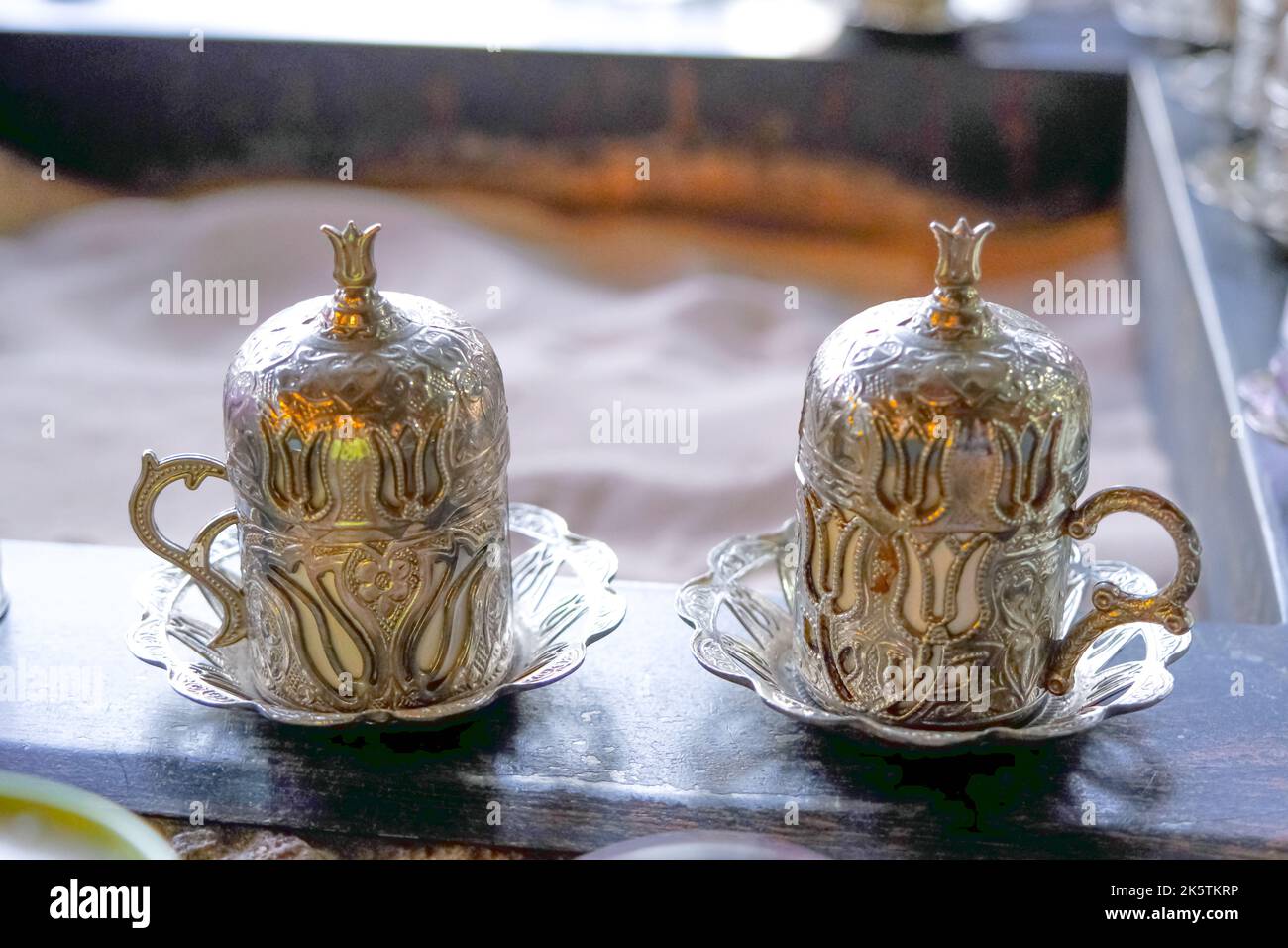 Copper cups with Turkish coffee cooked in hot sand Stock Photo - Alamy