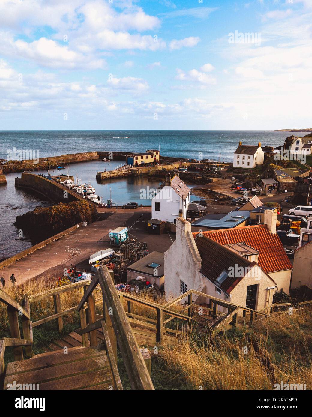 An aerial view of village St Abbs surrounded by buildings and water ...