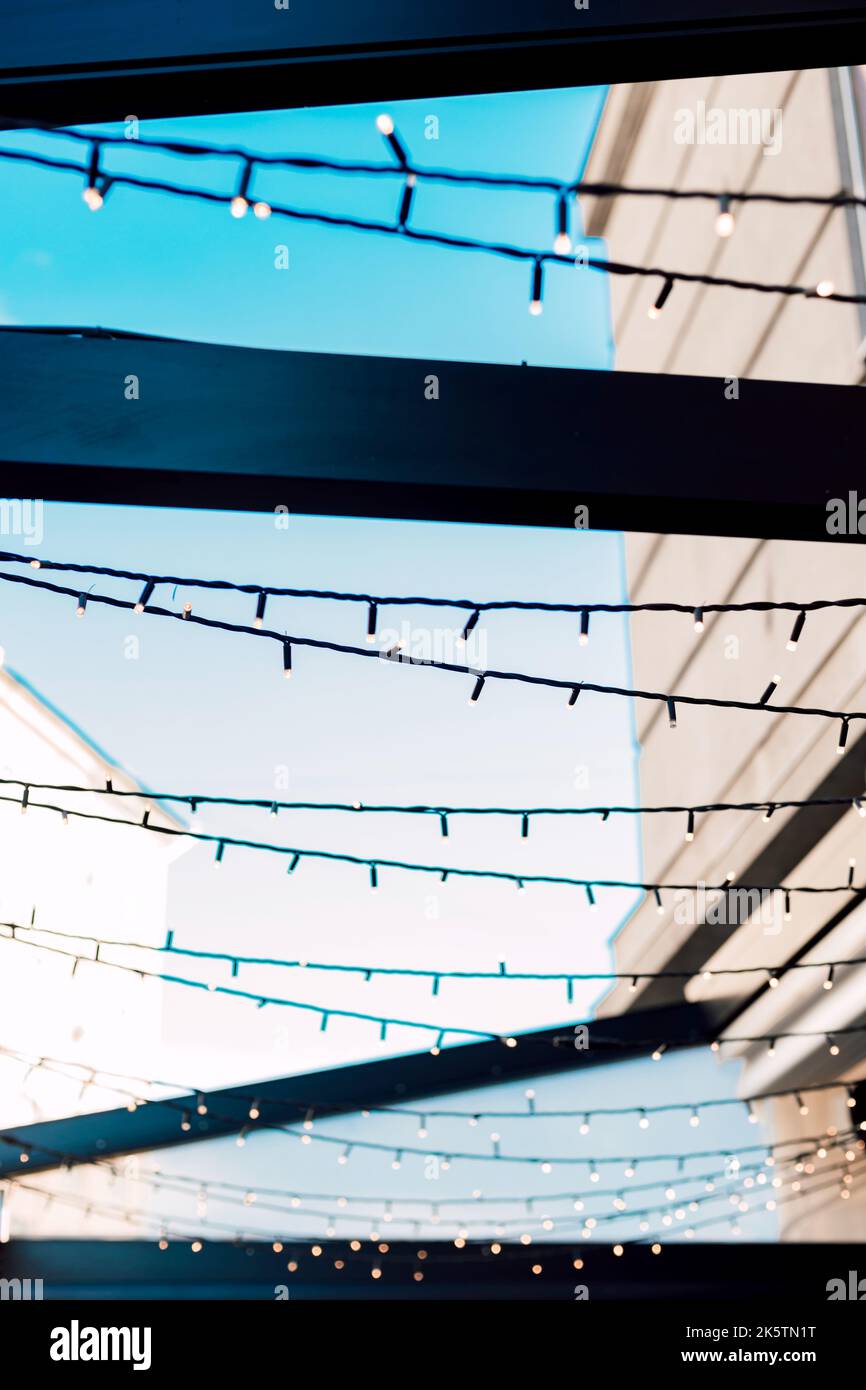 New Year's garlands against the blue sky. Decorations for Christmas in ...