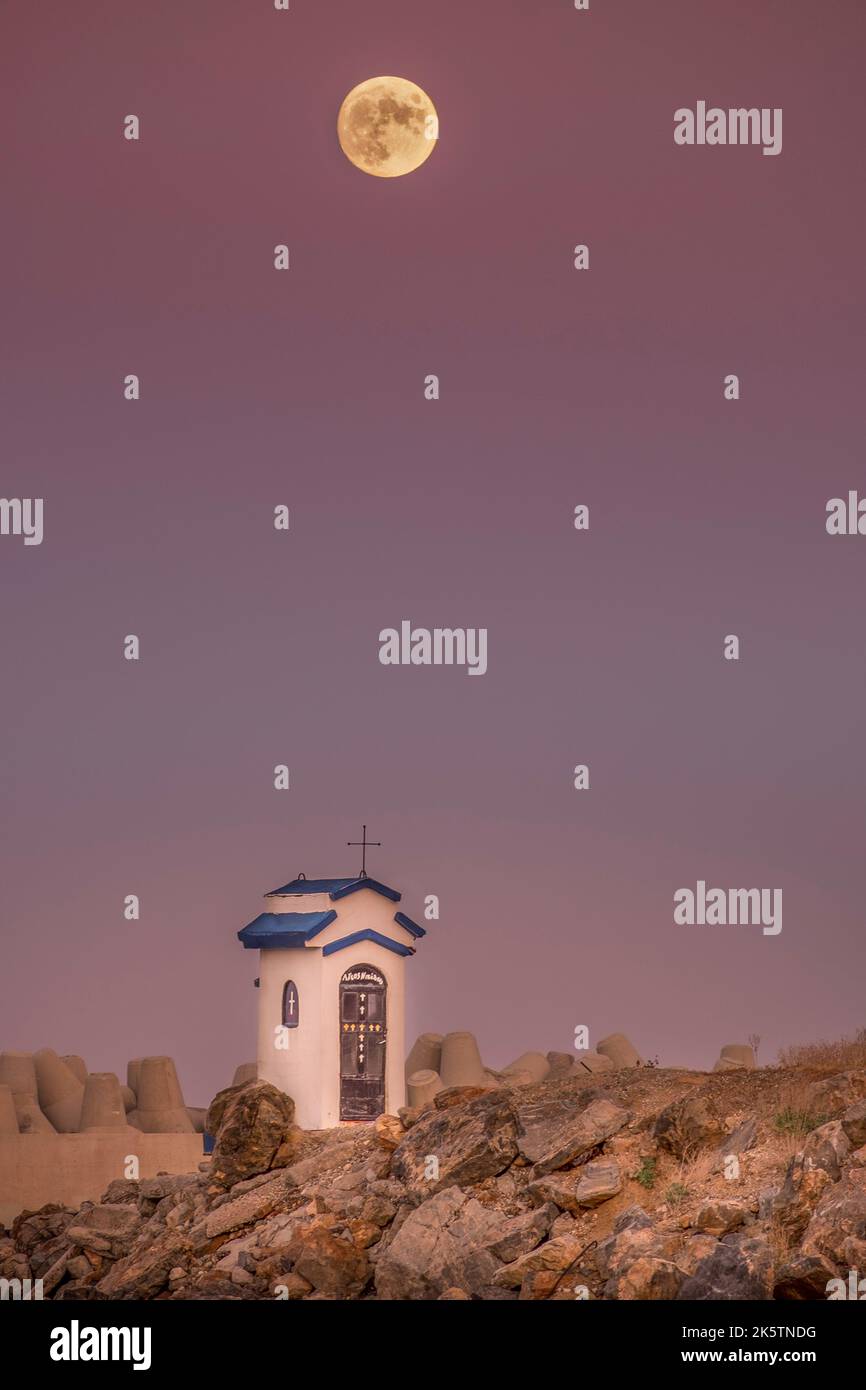 October's full moon over the chapel of saint Nicolaos at the port of ...