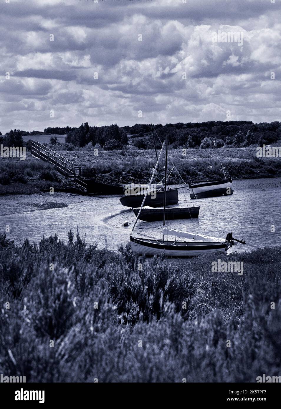 boats in mud berths stiffkey north norfolk england Stock Photo - Alamy