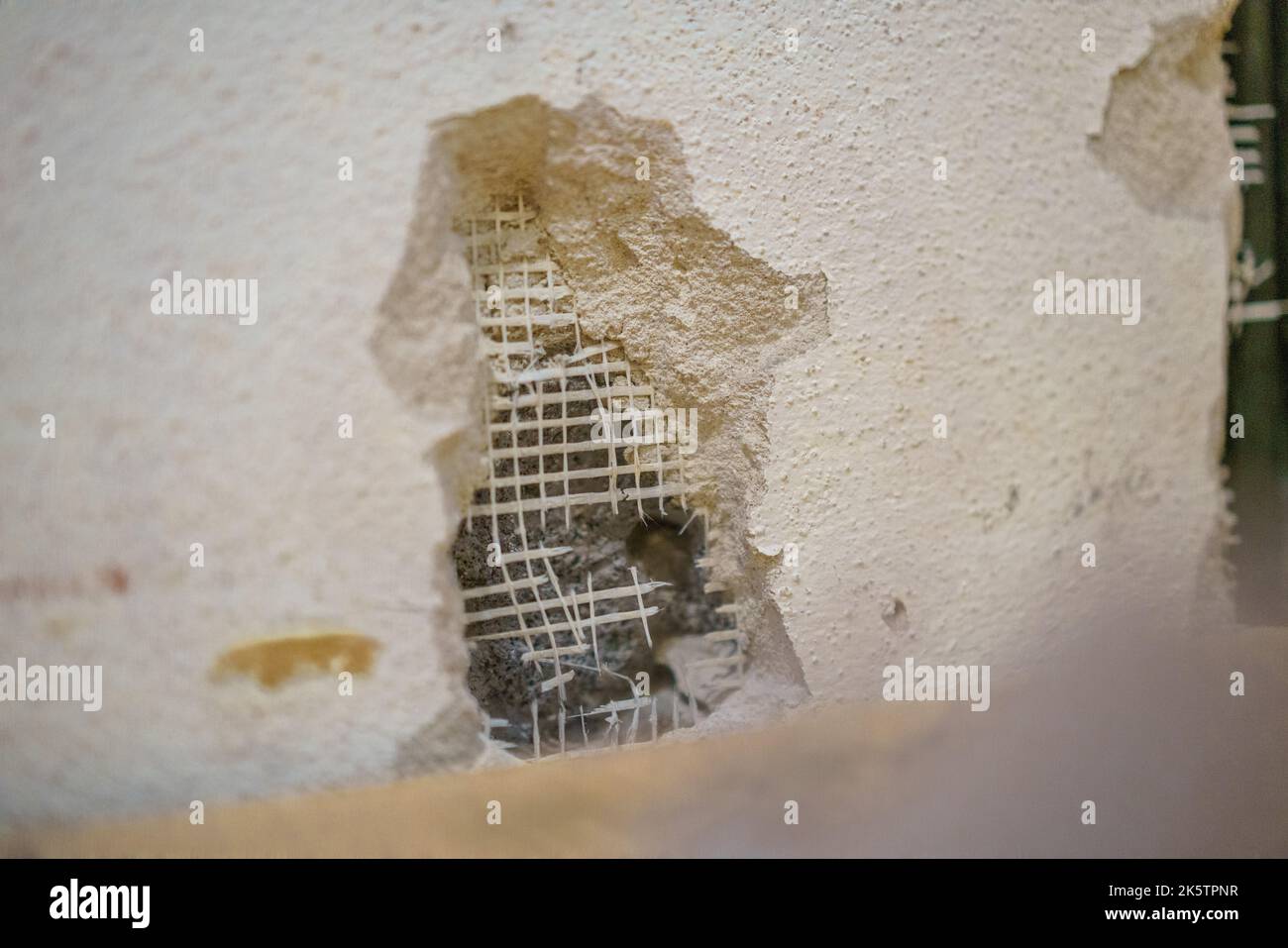 Hole in new white wall, after installation of electrical distribution ...